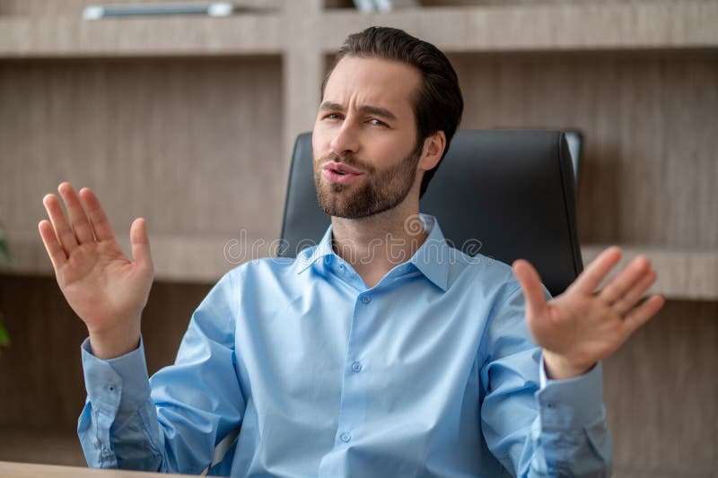 A Man Sitting in the Office and Looking Contented Stock Photo - Image ...
