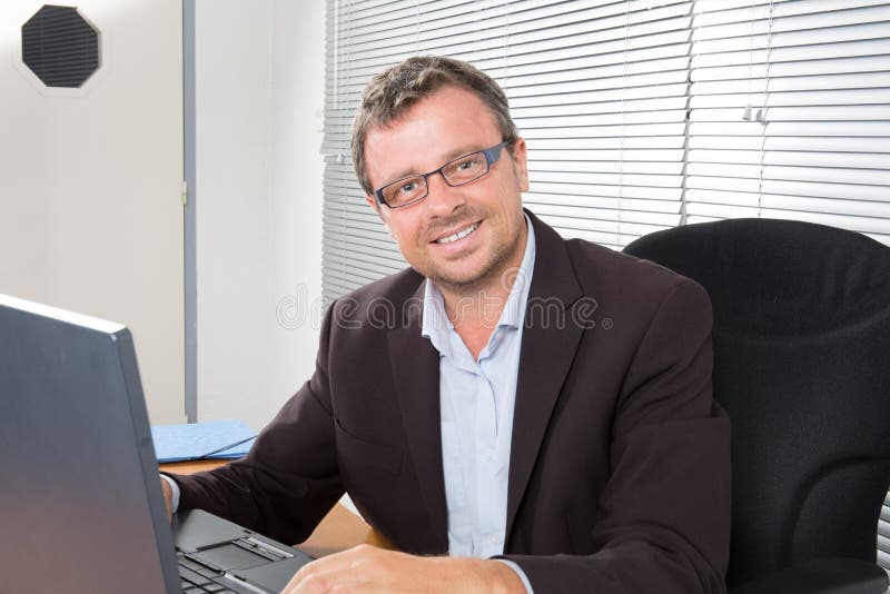 Man Sitting in Office Working on Computer Stock Photo - Image of person ...