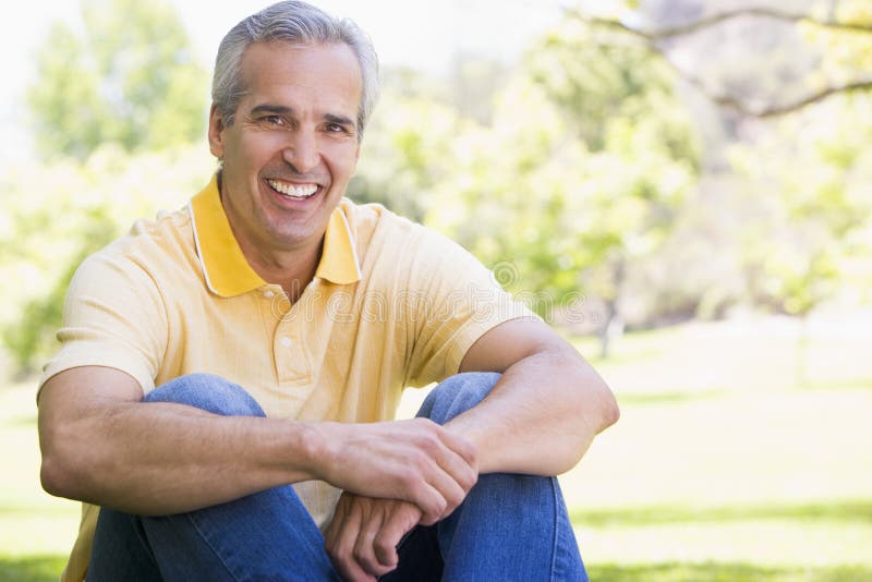 Man Sitting Outdoors Smiling Stock Image - Image of caucasian, baby ...