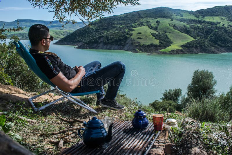 Man Sitting Overlooking Lake Picture. Image: 116147551