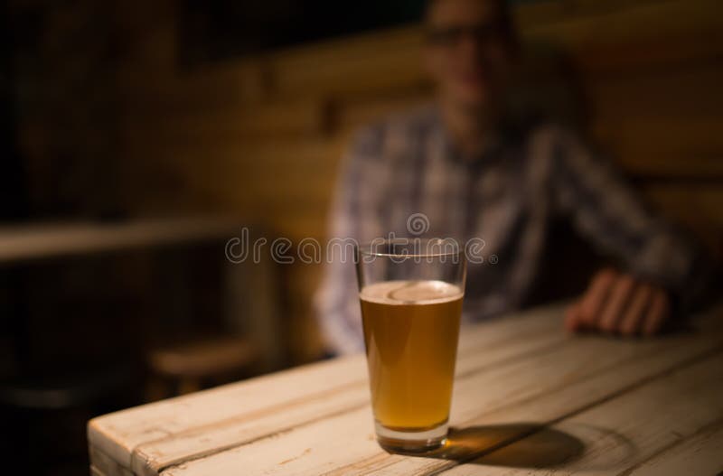 A Man is Sitting in a Pub in Front of a Craft Beer Stock Photo - Image ...