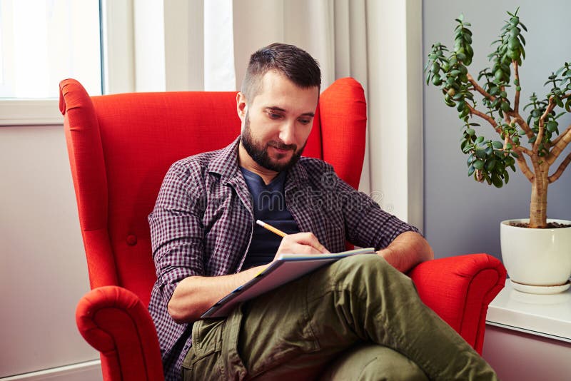 Man Sitting Red Chair Writing Something Stock Photos - Free & Royalty ...