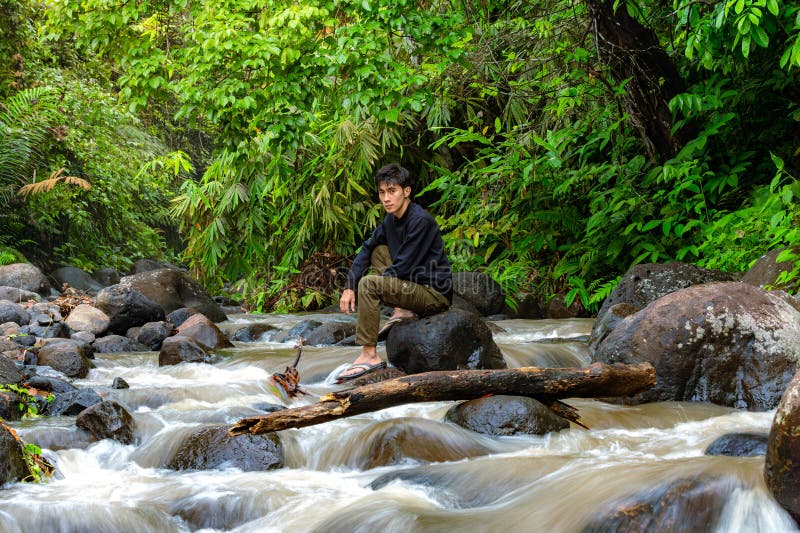 Man Sitting on the River while Looking Around. Lonely Man Sitting Alone ...