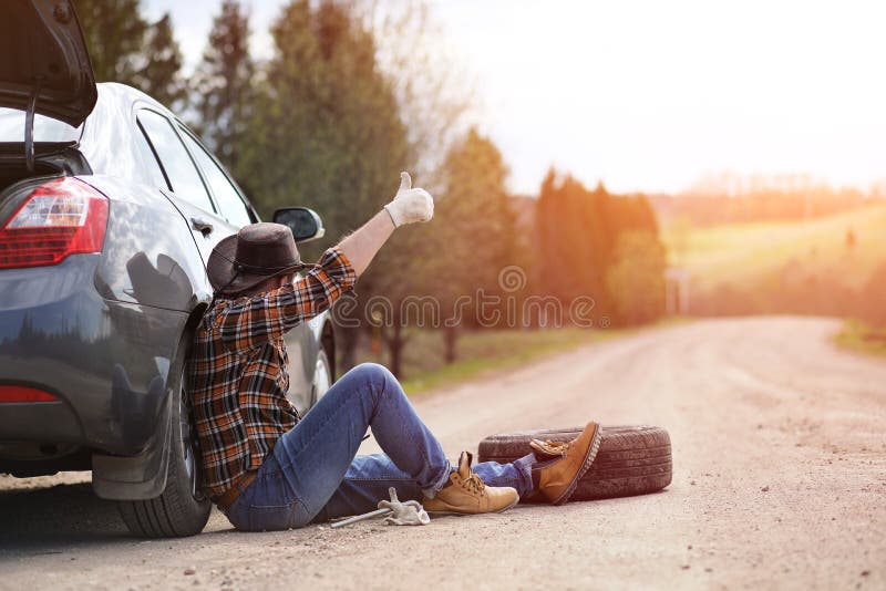 Man is Sitting on the Road by the Car Stock Photo - Image of head ...
