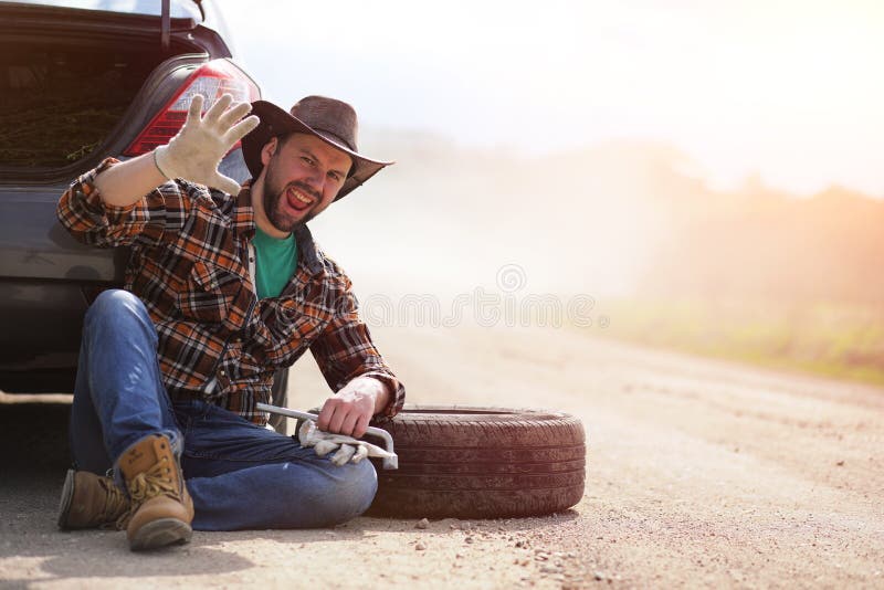 Man is Sitting on the Road by the Car Stock Photo - Image of driver ...