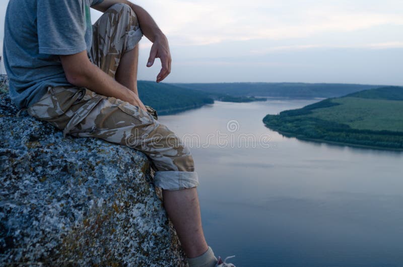 Man Sitting on a Rock Above the River at Sunset Stock Photo - Image of ...