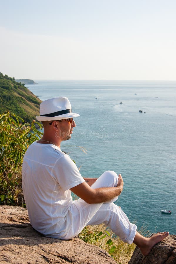Man Sitting on a Rock and Looking at the Sunset of Phuke Stock Photo ...