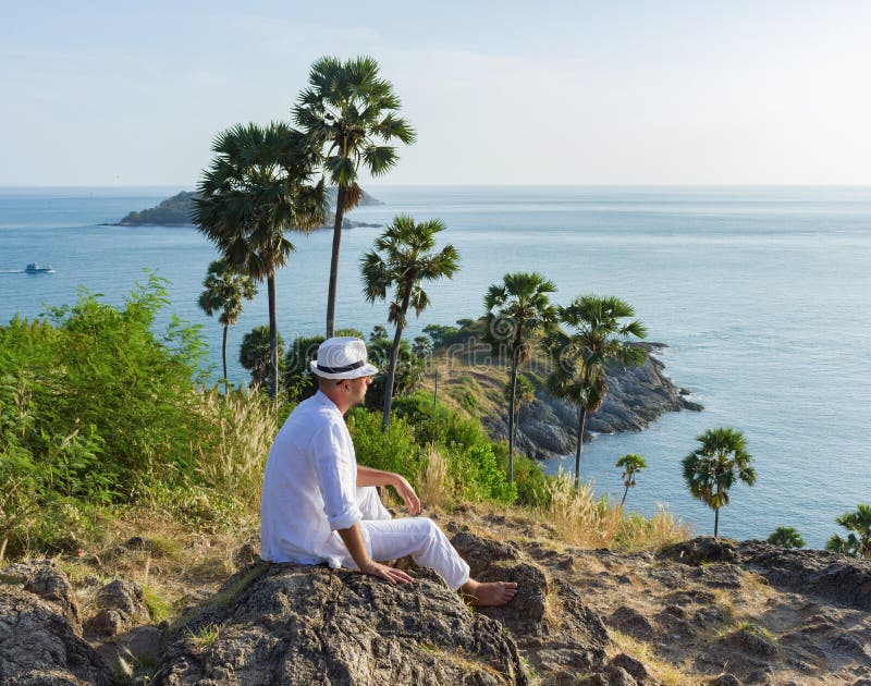 Man Sitting on a Rock and Looking at the Sunset of Phuke Stock Image ...