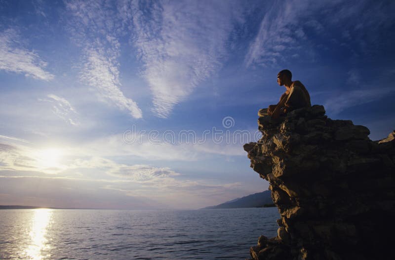 Man Sitting on Rock Overlooking Ocean Stock Image - Image of challenge ...