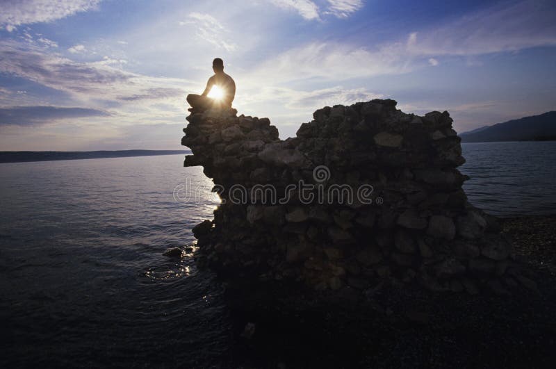 Man Sitting on Rock Overlooking Ocean Stock Photo - Image of formation ...