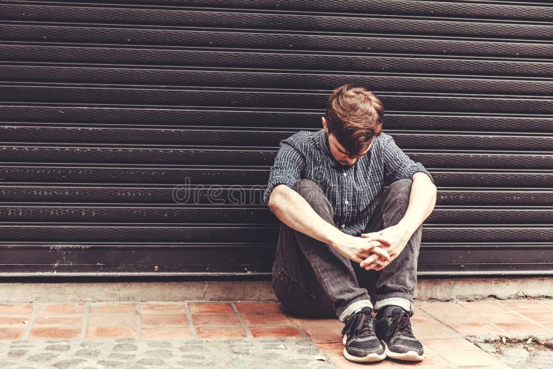A Man sitting sad alone stock photo. Image of loss, alone - 241760786
