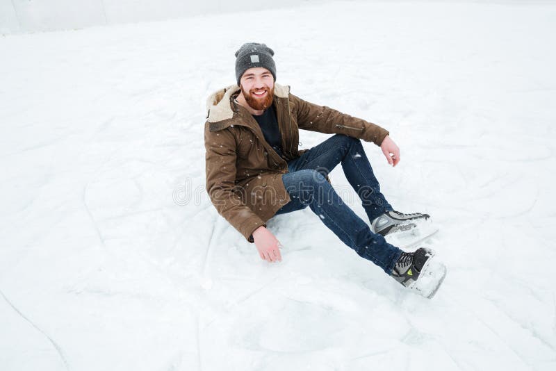 Man Sitting on the Snow in Ice Skates Stock Photo - Image of skating ...