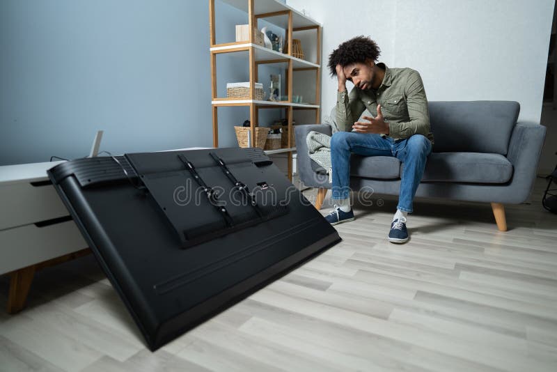 Man Sitting on Sofa in Front Fallen Television Stock Photo - Image of ...