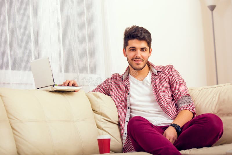 Man Sitting on Sofa with Laptop Stock Photo - Image of contemporary ...