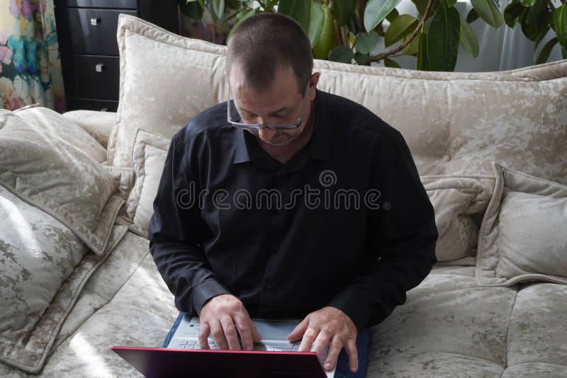 Man Sitting on Sofa and Working on Laptop Stock Photo - Image of aging ...