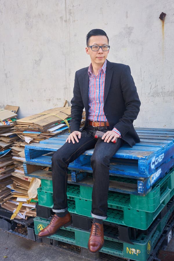 Man Sitting on a Stack of Pallets Stock Image - Image of adult, person ...