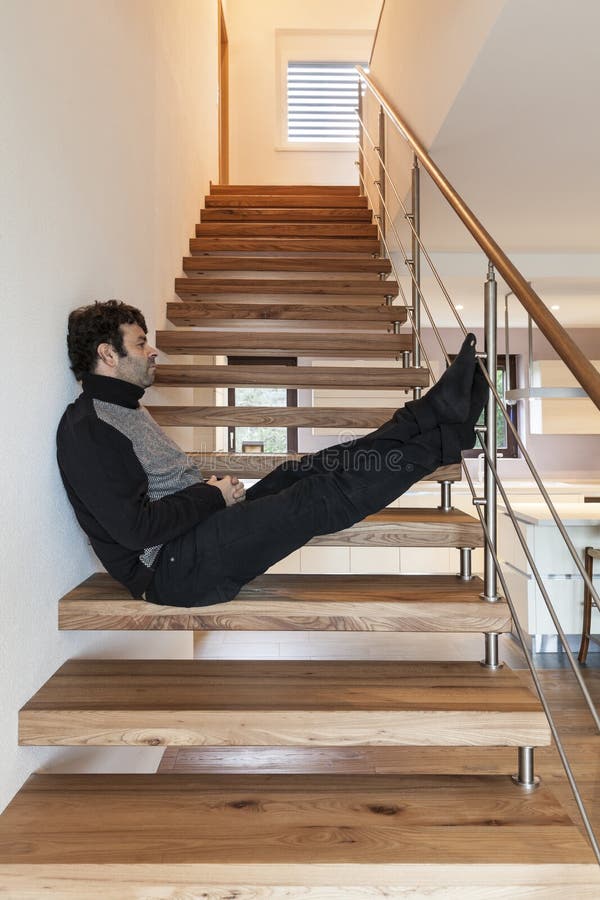 Man sitting on the stairs stock photo. Image of hardwood - 29303992