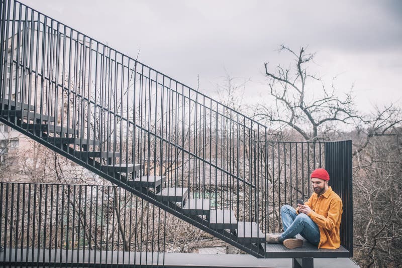Man Sitting on the Steps of the City Bridge Stock Photo - Image of ...