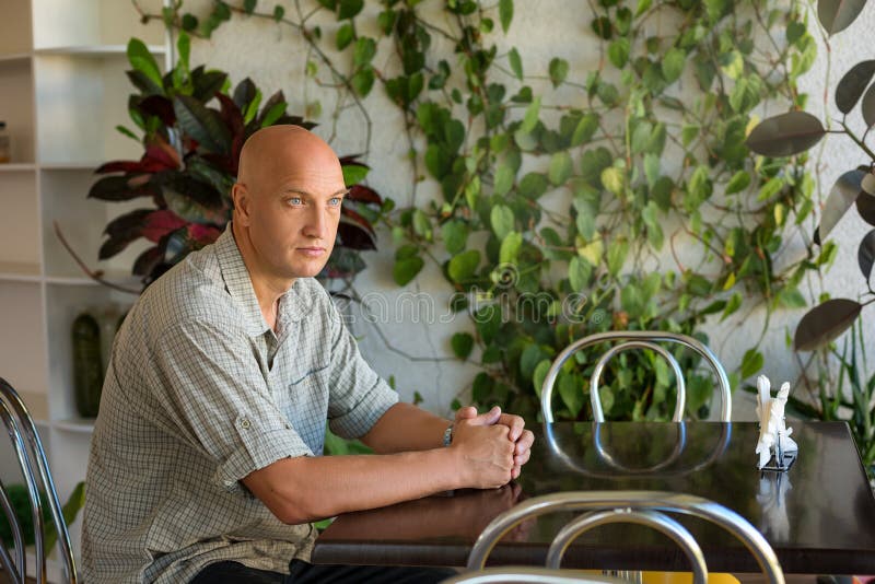 A Man Sitting at a Table in a Cafe Stock Photo - Image of male ...