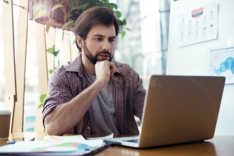 Man Sitting at the Table at Creative Stylish Office Looking at L Stock ...