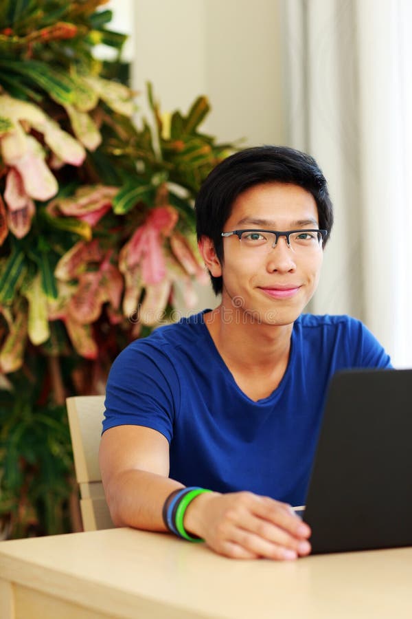 Man Sitting at the Table with Laptop Stock Photo - Image of asian ...