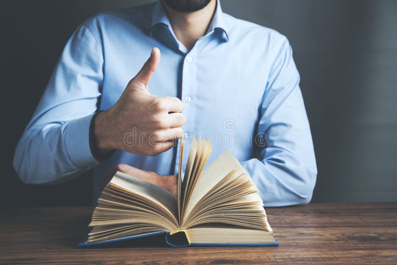 Man Sitting at a Table Reading a Book Stock Photo - Image of student ...