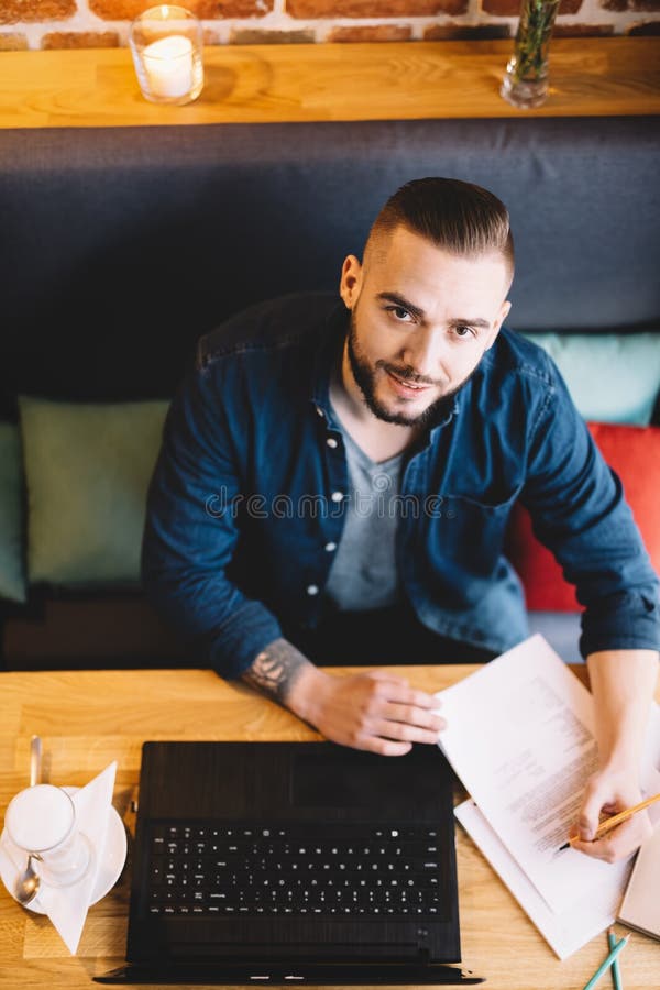Man Sitting by the Table, Working. Stock Image - Image of internet ...