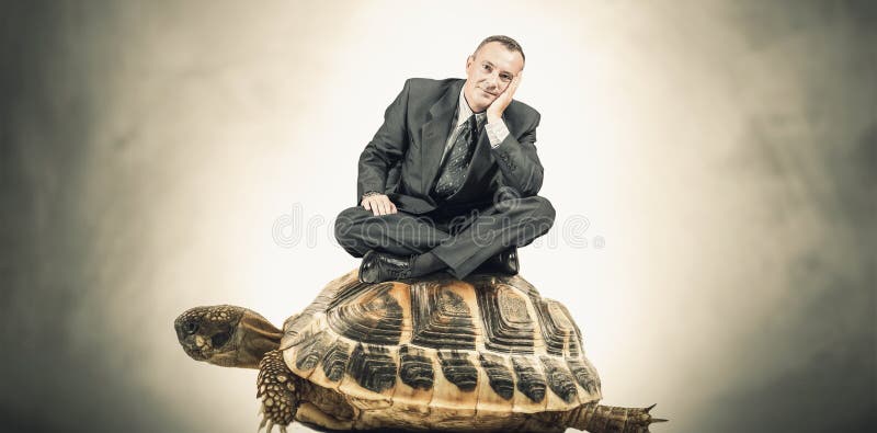 Man sitting on a turtle stock photo. Image of success - 101466470