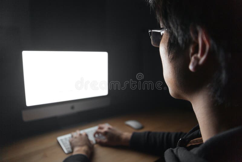 Man Sitting and Using Blank Screen Computer in Dark Room Stock Photo ...