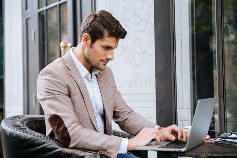 Man Sitting and Using Laptop in Outdoor Cafe Stock Photo - Image of ...