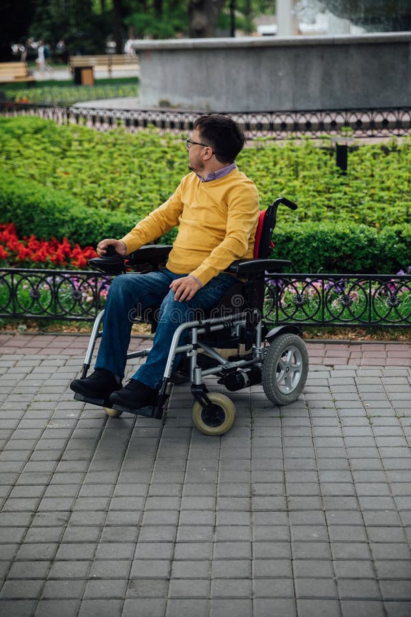 Man Sitting in a Wheelchair on a Walk in the City Stock Image - Image ...