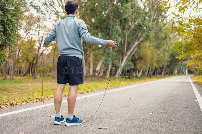 Man Skipping with Jump Rope in the Park Stock Photo - Image of shoes ...