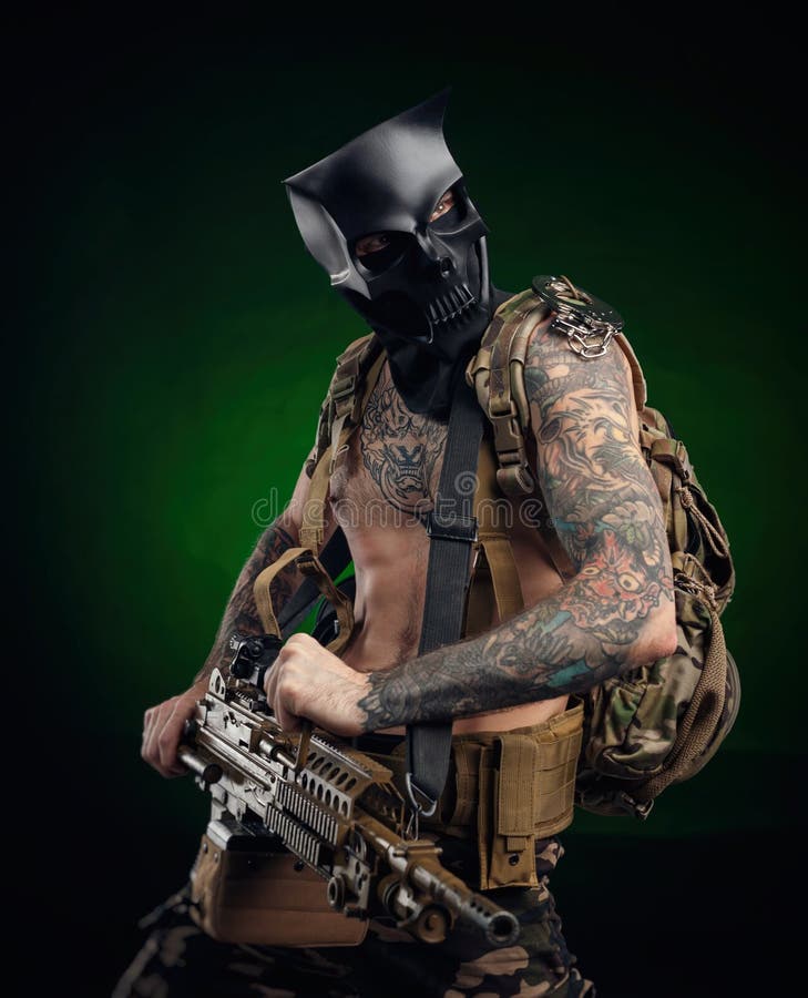 A Man in a Skull Mask with a Machine Gun in His Hands in Tattoos Stock ...