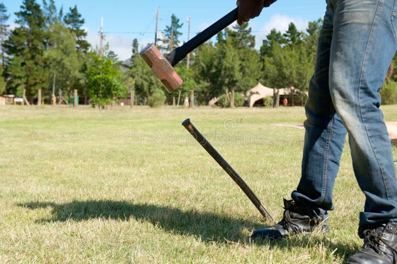 Man with Sledgehammer Hitting Large Metal Spike Stock Image - Image of ...