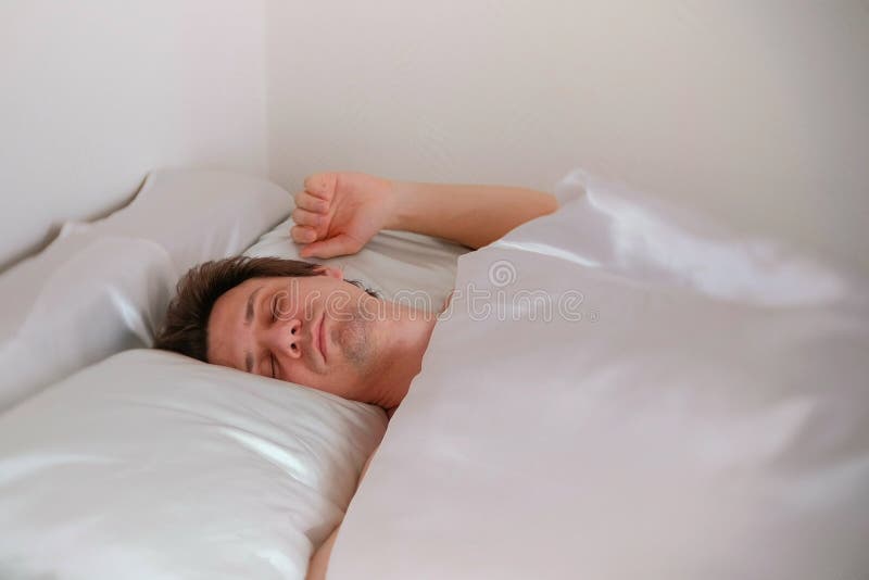 Man is Sleeping in Bed Alone Under the Blanket. Side View. Stock Photo ...