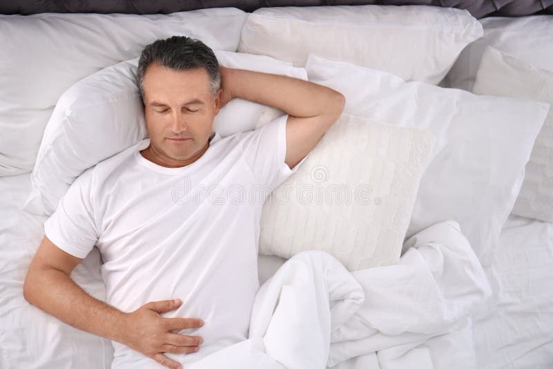 Man Sleeping on Comfortable Pillow in Bed at Home Stock Photo - Image ...