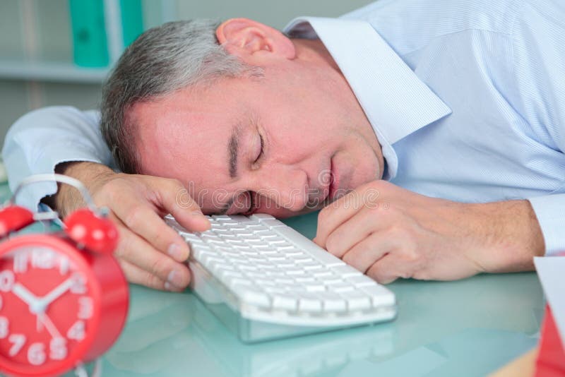 Man Sleeping on Desk in Bright Modern Office Stock Image - Image of ...