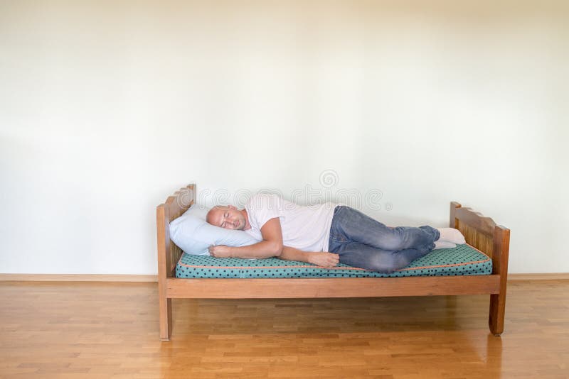 A Man is Sleeping on an Empty Bed in an Empty Room. the Concept of ...