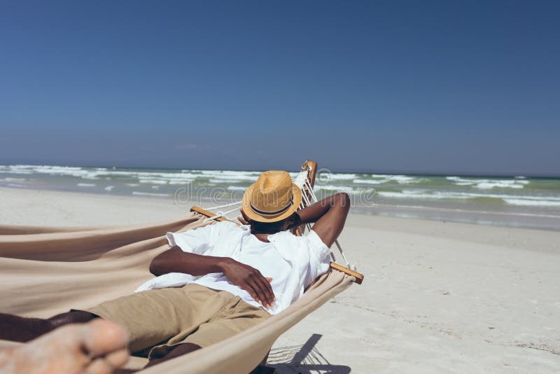 Man sleeping on the beach stock image. Image of laying - 64679833