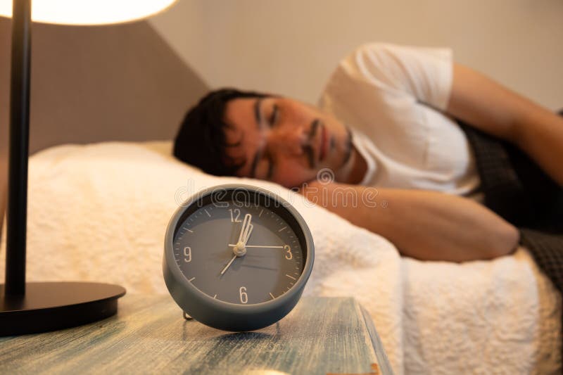 Man Sleeping on His Side in the Night Hours Next To an Alarm Clock ...