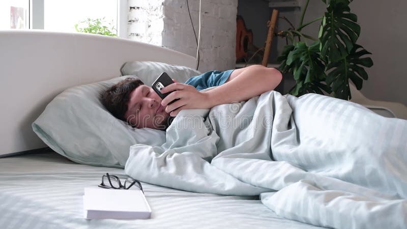 Man Sleeping Looking at Screen Mobile Phone Smartphone Lying in the Bed ...
