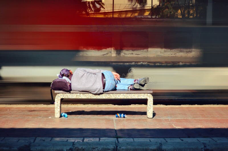 Man Sleeping on a Railway Station Bench Facing the Moving Train Stock ...