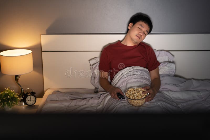 Man Sleeping while Watching Tv on a Bed at Night Stock Image - Image of ...