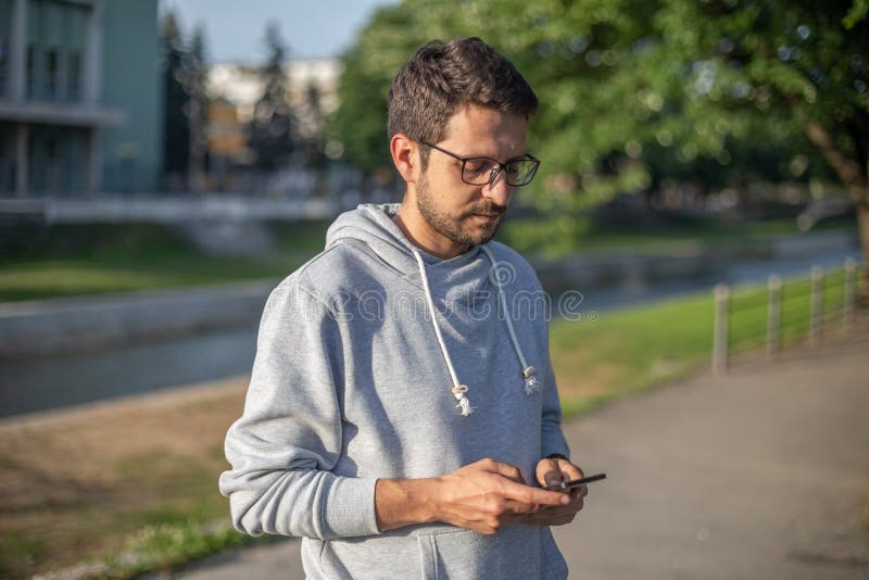 Man on Smartphone in Park, Back Light Stock Photo - Image of hand, cell ...