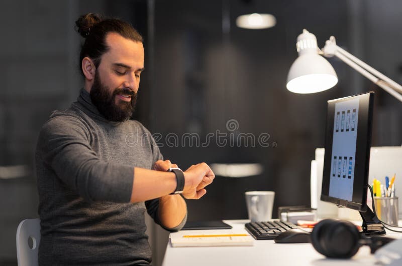 Man with Smartwatch and Computer at Night Office Stock Image - Image of ...