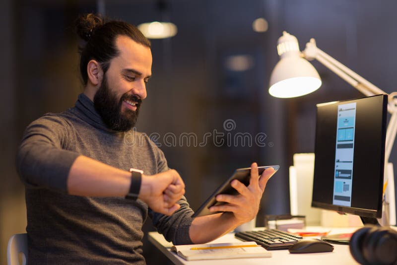 Man with Smartwatch and Tablet Pc at Night Office Stock Image - Image ...