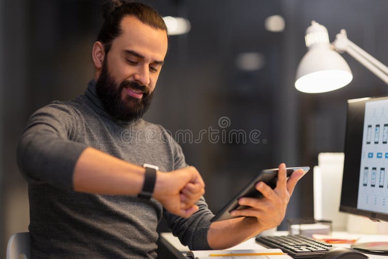 Man with Smartwatch and Tablet Pc at Night Office Stock Photo - Image ...