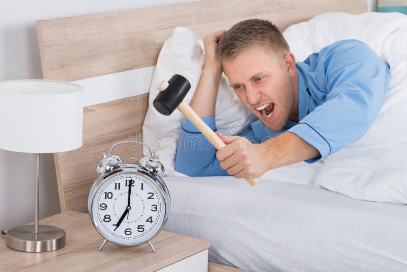 Man Smashing Alarm Clock with Hammer Stock Image - Image of home ...