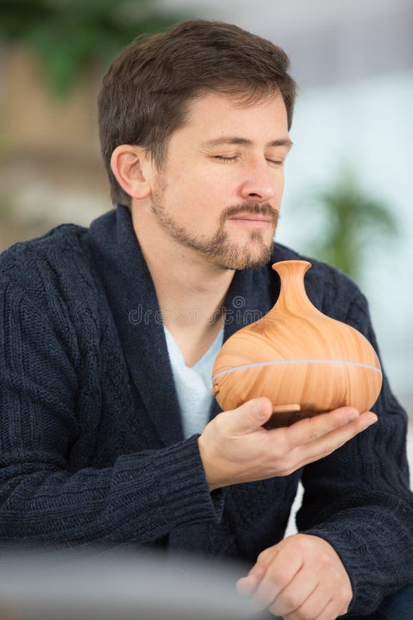 Man Smelling Essential Oil from Aroma Diffuser Stock Photo - Image of ...