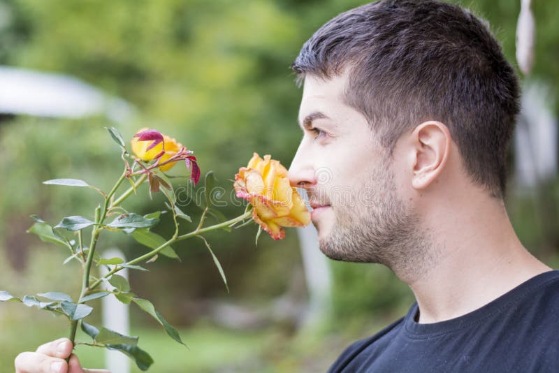 Man smelling a rose stock image. Image of friendly, garden - 60627089